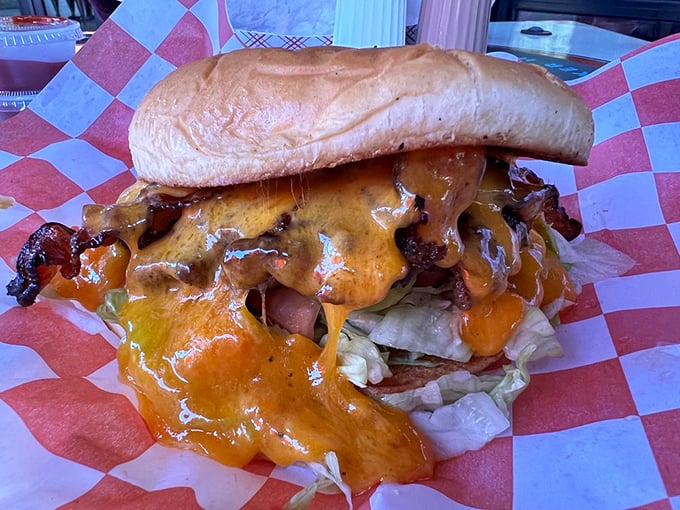 The cheese doesn't just top this burger—it engulfs it like a dairy avalanche. This is what burger dreams are made of.