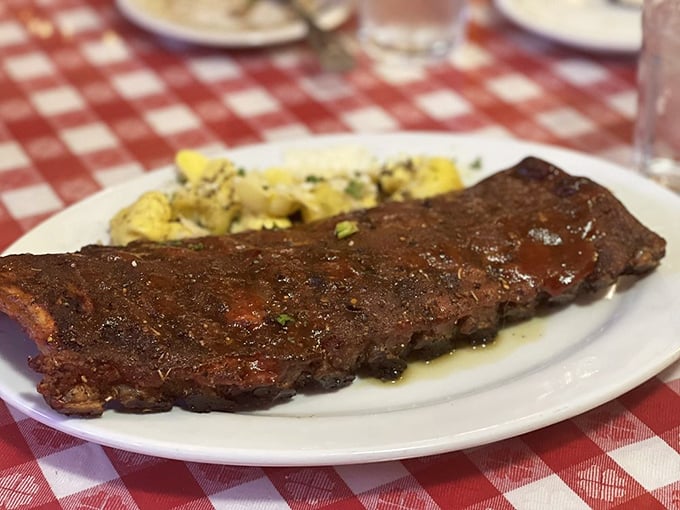 These ribs aren't just falling off the bone—they're practically filing for independence, with a sauce that should be bottled and sold as liquid gold.