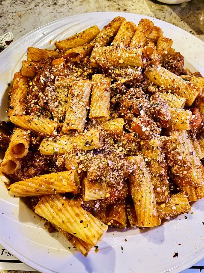 Rigatoni that doesn't just hold the sauce—it embraces it like a long-lost relative. That generous dusting of cheese is the edible equivalent of a warm Italian hug.