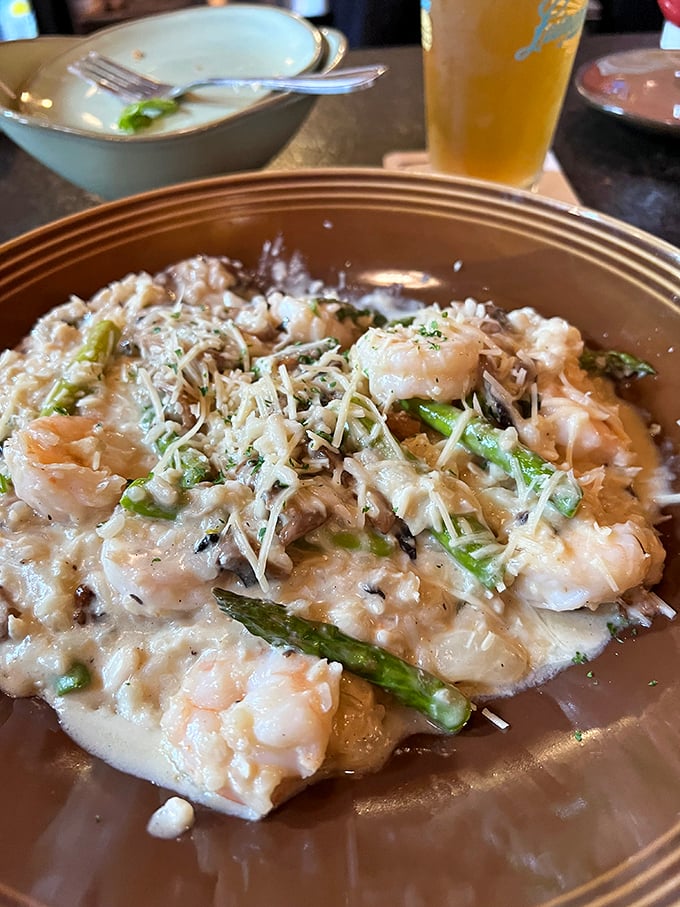Creamy risotto studded with plump shrimp and tender asparagus—proof that comfort food can wear fancy clothes when it wants to impress.