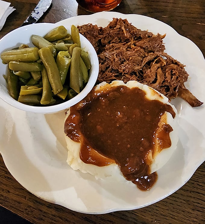 Pot roast swimming in gravy alongside green beans – this plate could make a grown man call his mother.