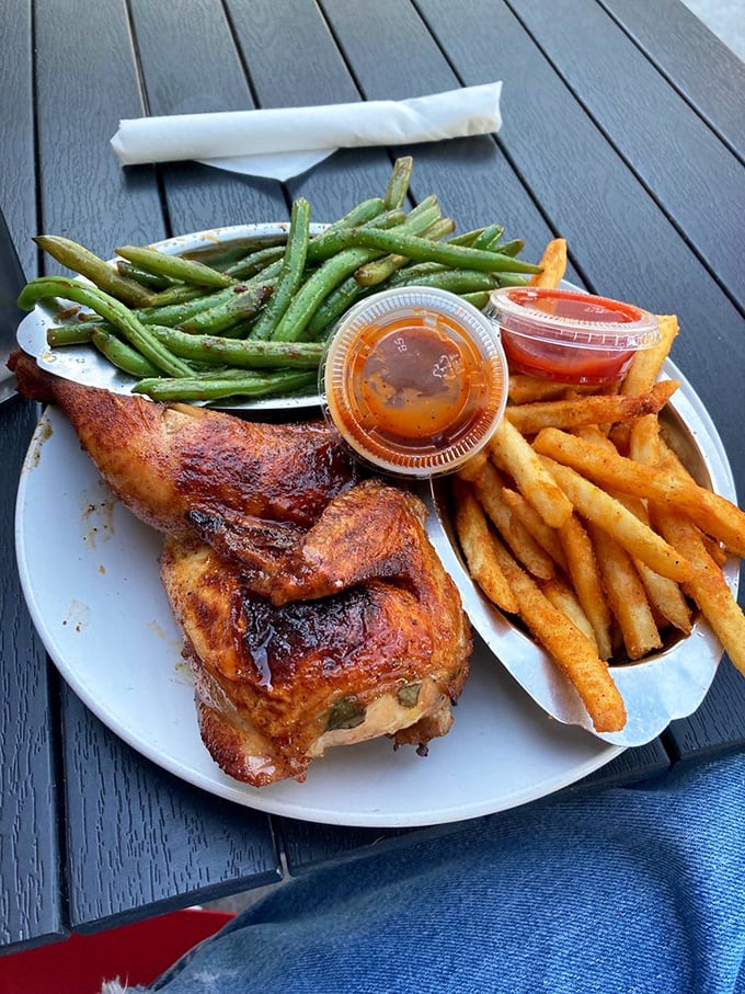 This isn't just chicken—it's poultry perfection. The skin crackles with flavor while those green beans and fries stand by as worthy companions.