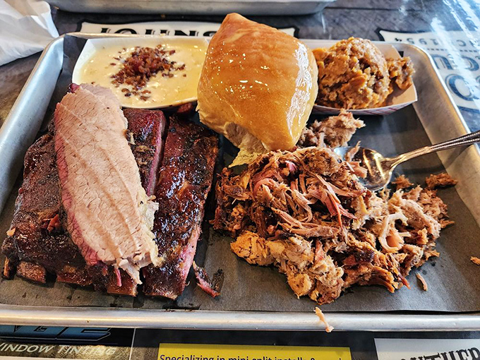 The BBQ sampler platter—nature's way of saying "you don't have to choose." Brisket, pulled pork, and a roll that's ready to soak up every last drop of sauce.