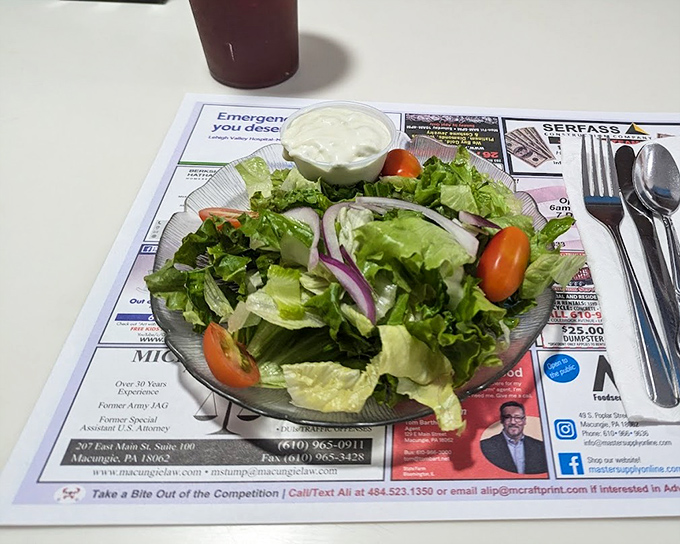 Even the side salad gets respect here – crisp greens, fresh vegetables, and a dressing on the side because they understand some decisions are personal.