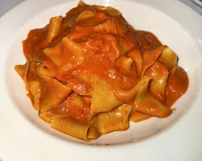 Pasta with red sauce so vibrant it could stop traffic—and so delicious you'll be plotting your return before the plate is empty.