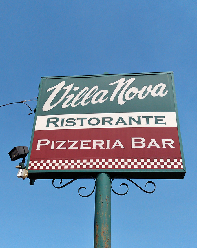 The iconic Villa Nova sign stands proud against blue Ohio skies. Those Italian flag colors aren't just decoration—they're a promise of the authentic experience waiting inside.