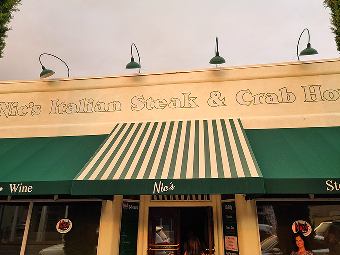The sign glows like a beacon for hungry travelers. Those green awnings have sheltered many eager diners waiting for their potato fix.