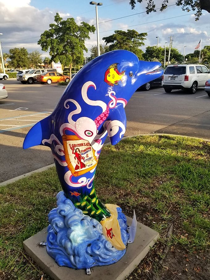A whimsical dolphin sculpture announces your arrival at seafood paradise with the subtlety of a cartoon character—and the charm to match.