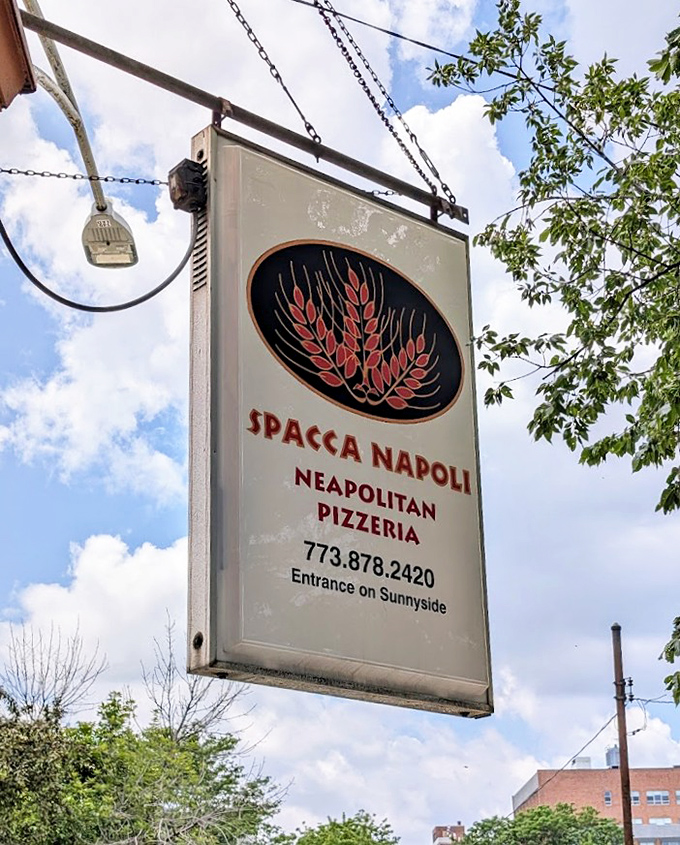 The sign beckons like an old friend, promising authentic Neapolitan pizza just around the corner. Follow it to happiness.