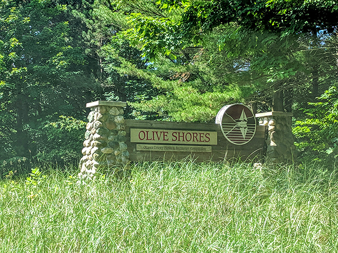 The unassuming entrance to Olive Shores belies the spectacular beauty waiting just beyond those stone pillars and tall pines.