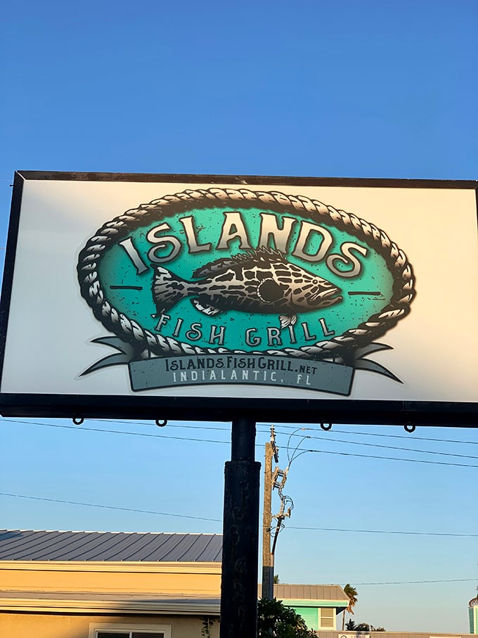 The roadside sign promises "Fish with an Attitude" against the Florida sky—a bold claim the kitchen consistently backs up with every plate.