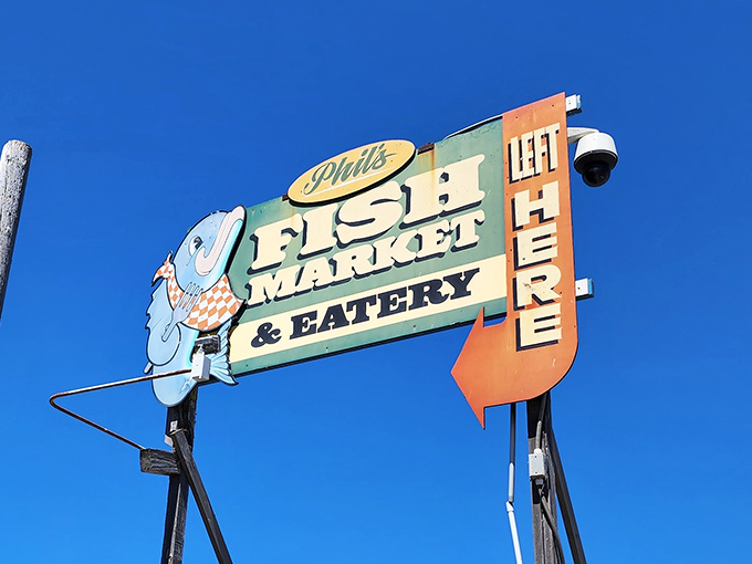 That retro sign pointing left isn't just directions—it's pointing the way to seafood enlightenment. The cartoon fish knows what you're in for.