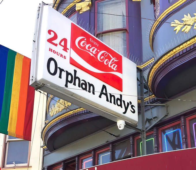 The classic Coca-Cola sign with rainbow pride flag announces to the world: good food and open hearts, 24 hours a day.