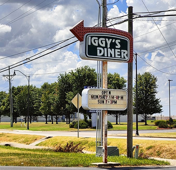 The vintage arrow sign points the way to happiness—operating hours included because good things shouldn't be kept waiting.