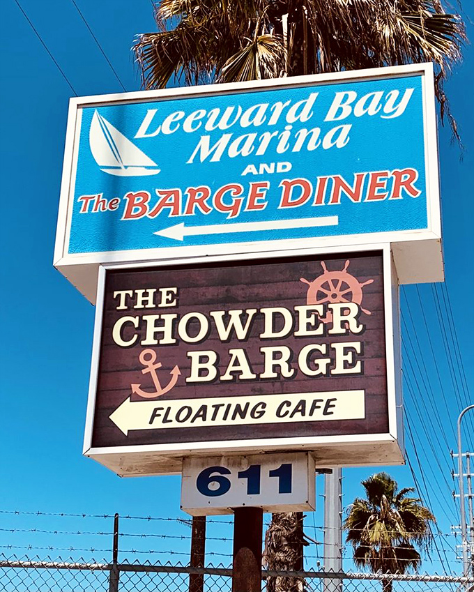 The sign stands as a beacon to hungry travelers—a promise of floating feasts and chowder dreams just waiting around the corner.
