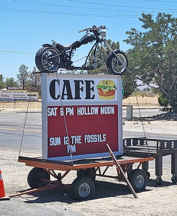 A motorcycle riding high above burger promises. This roadside sign doesn't just advertise food—it announces an experience worth the detour.