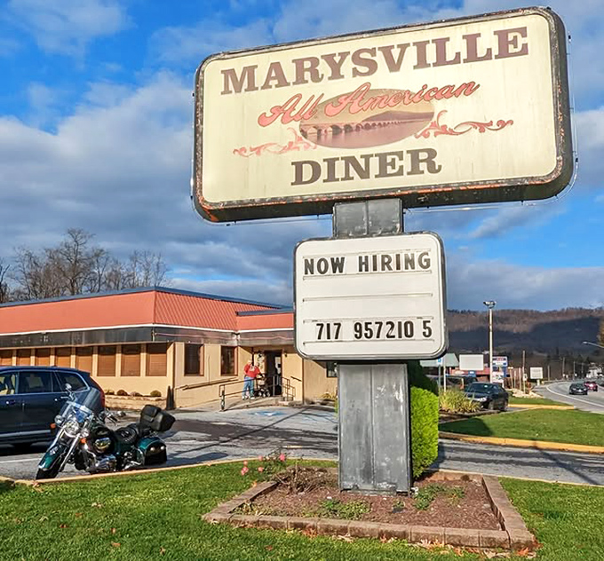 The sign promises "All American" and delivers exactly that—no pretension, just honest food and the promise of a full stomach.