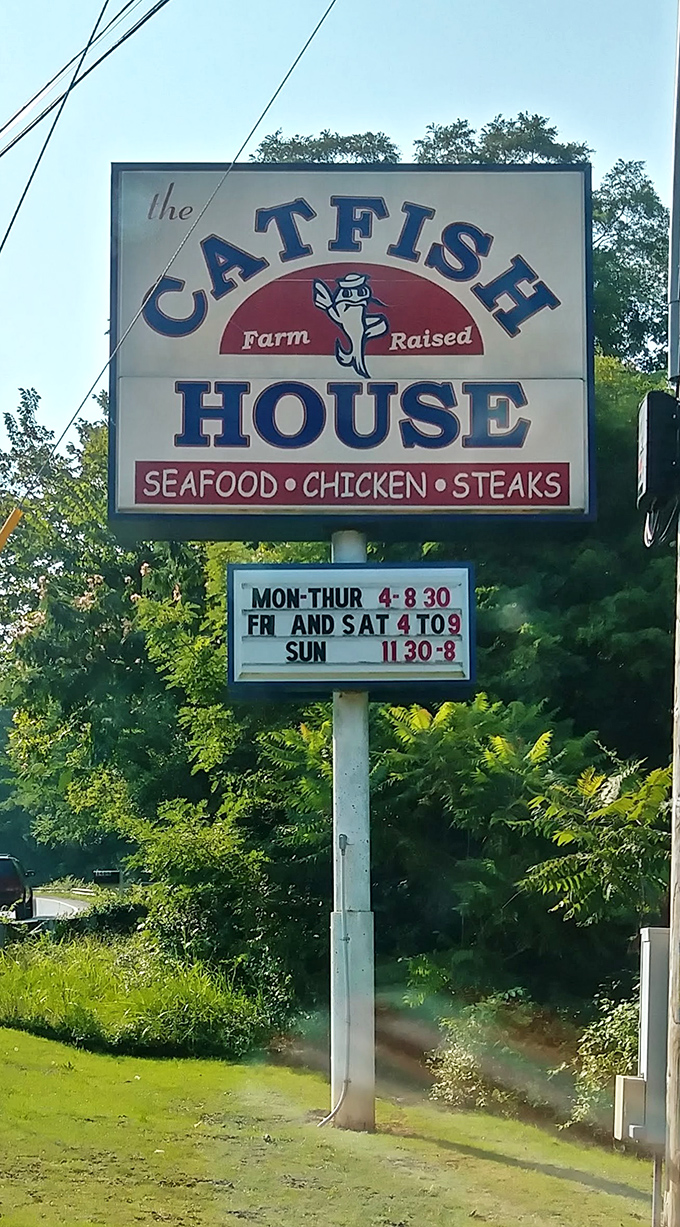 The roadside sign promises "Farm Raised" seafood and posts hours that feel like an invitation to the best kind of gathering.