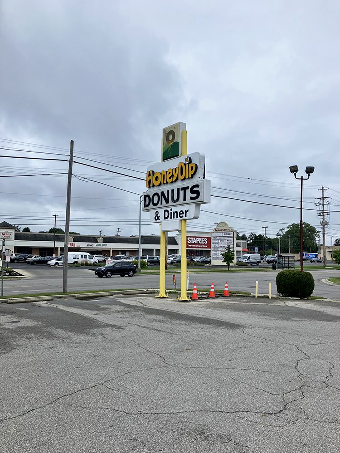 The roadside sign—a yellow beacon of hope for the hungry traveler. No fancy digital displays needed when the food speaks for itself.