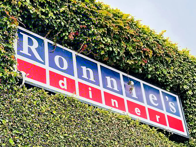 The iconic Ronnie's sign, nestled among greenery, has guided hungry Angelenos to pancake paradise for years.