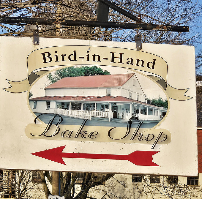 The sign that's guided countless hungry travelers to baked-good nirvana. That red arrow isn't just a direction—it's pointing toward your happiest caloric decisions.