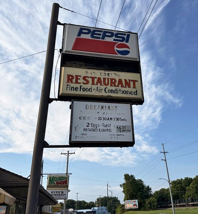 A roadside sign promising the holy trinity of American comfort: fine food, air conditioning, and breakfast specials that won't break the bank.