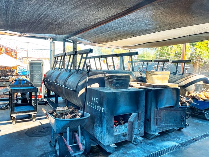 The source of the magic – massive smokers working their low-and-slow alchemy. These metal beasts transform ordinary meat into extraordinary memories.