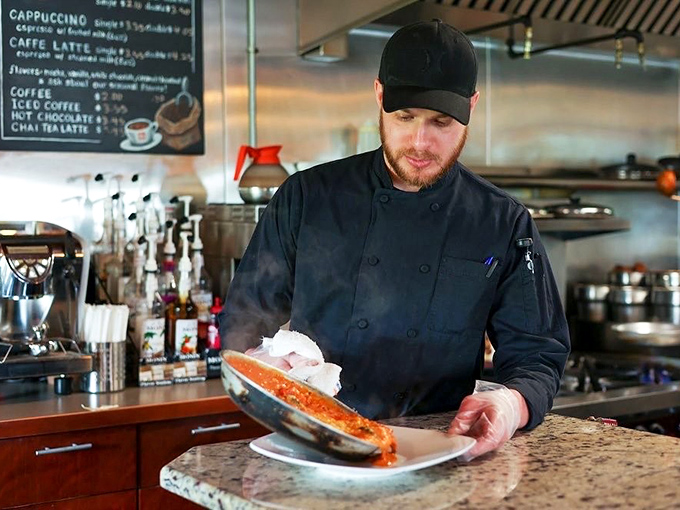 The chef in his natural habitat—where sauce-making is elevated to an art form that would make Michelangelo trade his paintbrush for a wooden spoon.