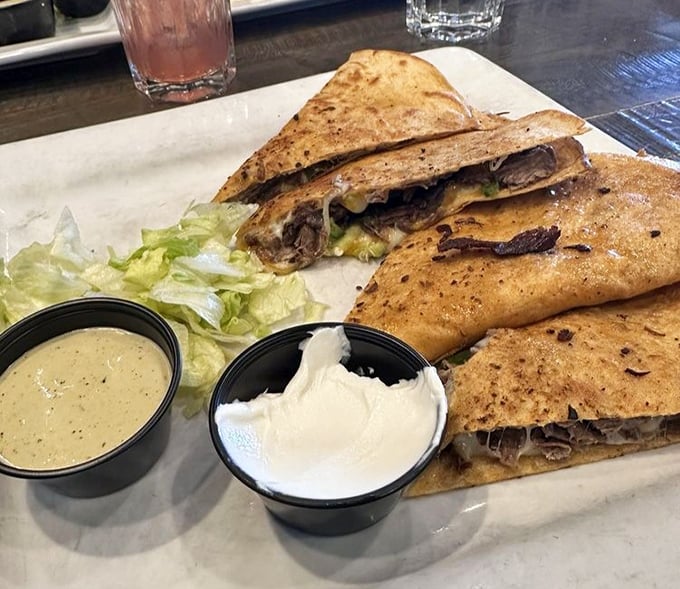 This quesadilla isn't just a meal, it's an architectural achievement—layers of melty cheese and steak folded into crispy perfection.
