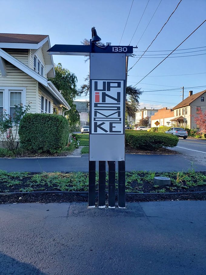 The street sign stands like a beacon of hope for the hungry – follow it to find your barbecue salvation.