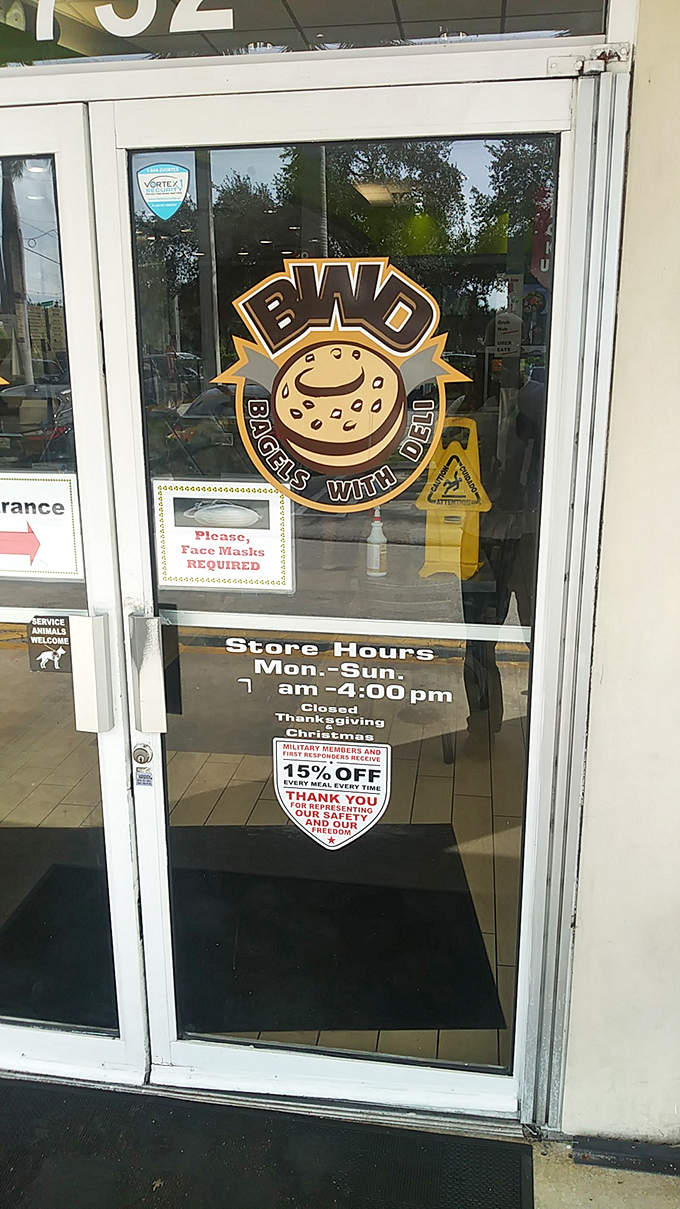 The logo that launches a thousand cravings. The cheerful bagel mascot and posted hours tell you everything you need to know – come early, come hungry.