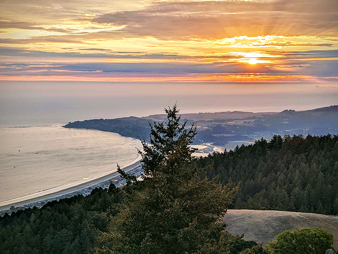 A sunset that doesn't just end the day—it celebrates it with a technicolor farewell party that makes you forget you have to hike back to your car.