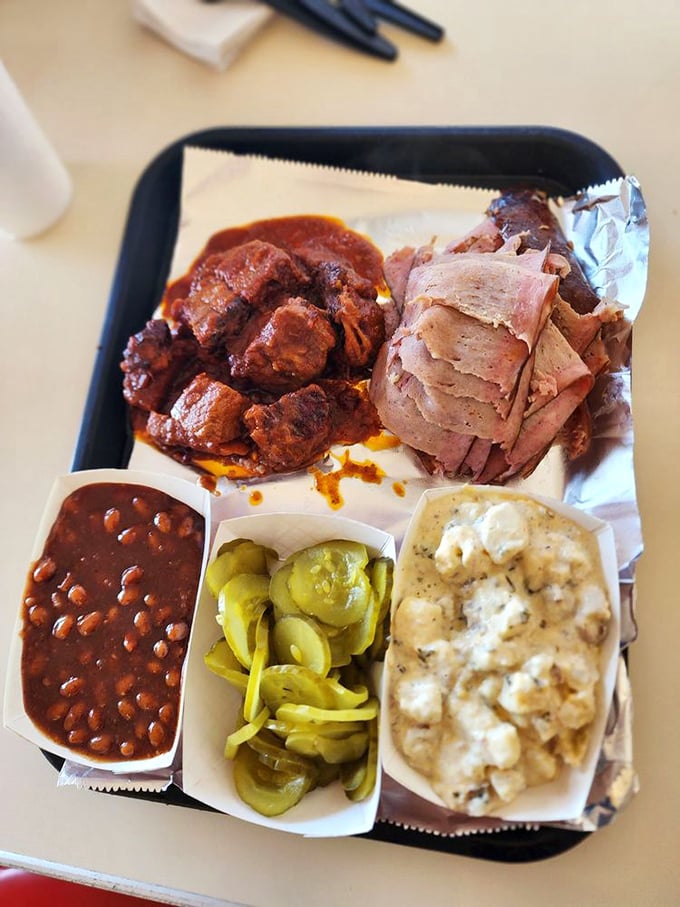 A tray that tells the complete Kansas City BBQ story. Meat, sides, and pickles—the holy trinity of proper barbecue consumption.
