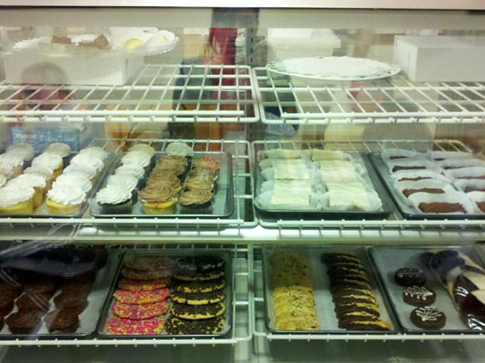The dessert case—where willpower goes to die and "I'll just have a bite" becomes the day's most optimistic fiction.