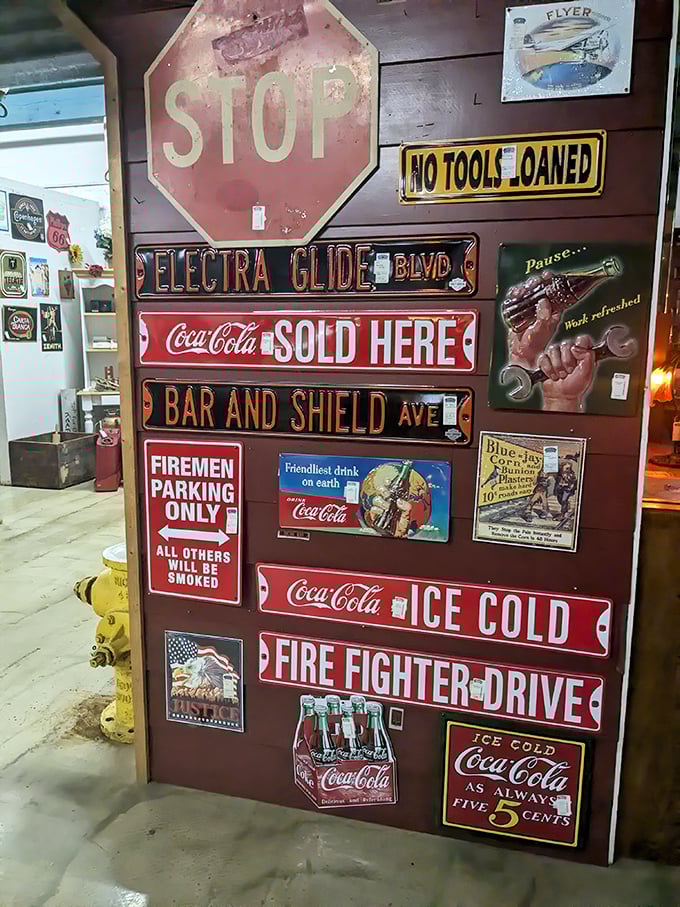 A wall of vintage signage that screams Americana—where Coca-Cola is always five cents and firemen get the best parking spots.