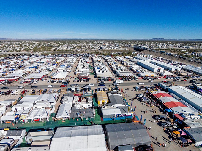 From above, the true scale of this desert phenomenon reveals itself—a temporary city of white tents and dreams stretching toward the horizon.
