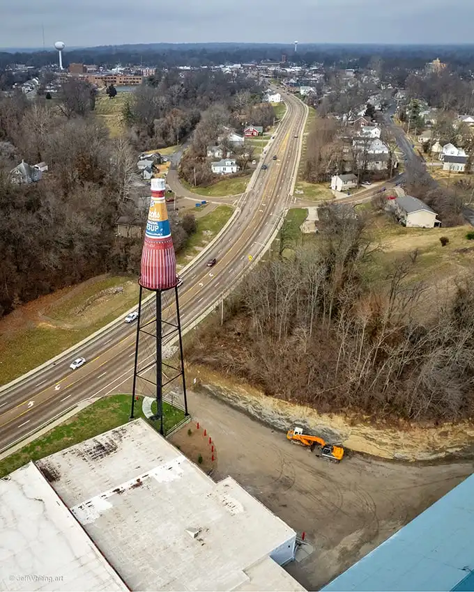 From above, the bottle stands sentinel over Collinsville. Not all heroes wear capes—some wear vintage catsup labels.