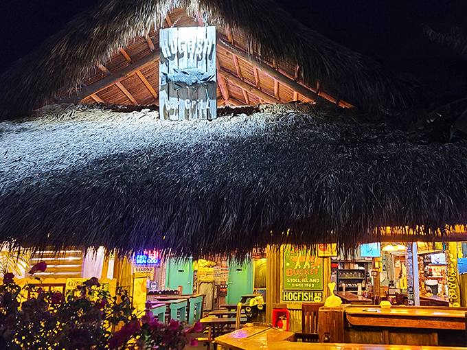 As night falls, the thatched roof glows with warm light, creating the perfect backdrop for that "wish you were here" social media post.