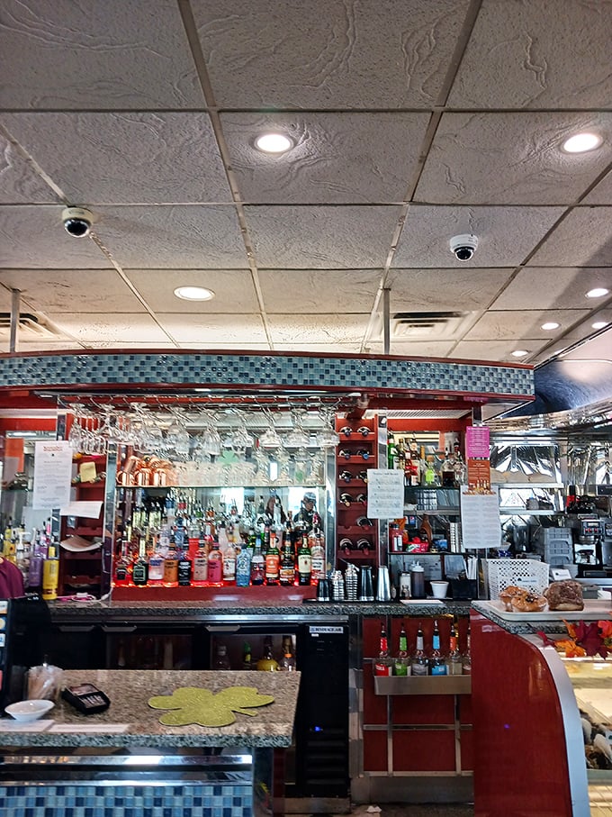 The bar area gleams with promise, bottles standing at attention like soldiers ready to serve in the battle against ordinary evenings.