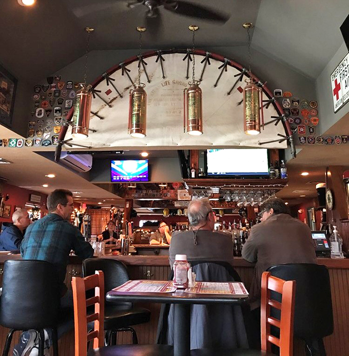 The bar's copper fire extinguishers hanging overhead aren't just decoration—they're a promise that the only heat you'll feel is from the delicious food.