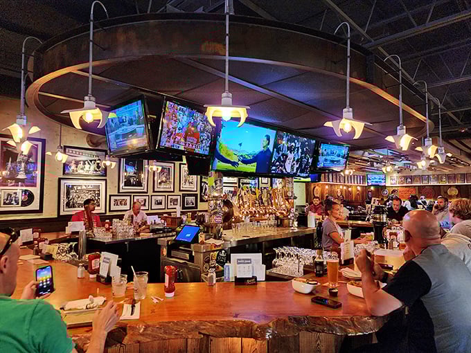 The beating heart of The Pour House—where bartenders orchestrate liquid happiness and TVs ensure you never miss a game-changing play.