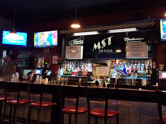 The bar at MST—where liquid refreshment meets wing enthusiasm. Notice the perfectly aligned bottles standing at attention, ready for service.