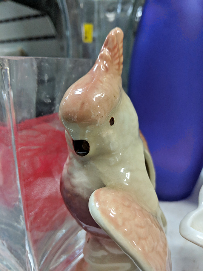 Vintage ceramic bird figurine that somehow manages to be simultaneously hideous and completely irresistible—the essence of thrift store magic.