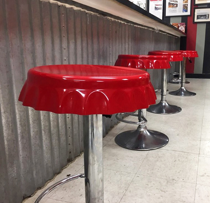 Bottle cap-shaped stools at the counter—where sitting down is the first step in a journey of delicious decisions.