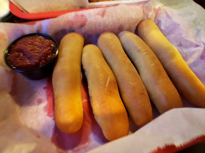 Breadsticks that achieve the perfect balance—crusty exterior giving way to pillowy centers, ready for their marinara sauce bath.