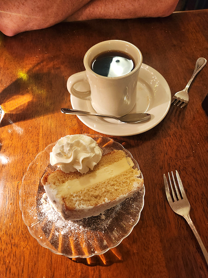 Coffee and cake—civilization's greatest achievement. That slice isn't dessert, it's the period at the end of a delicious sentence.