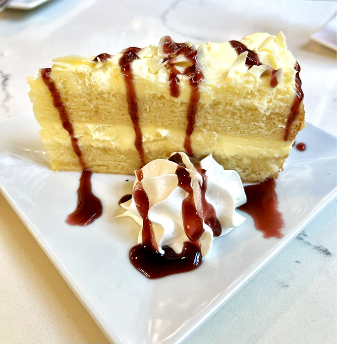 This isn't just cake—it's a towering achievement of butter, sugar, and skill that makes you wonder why anyone bothers with chocolate.