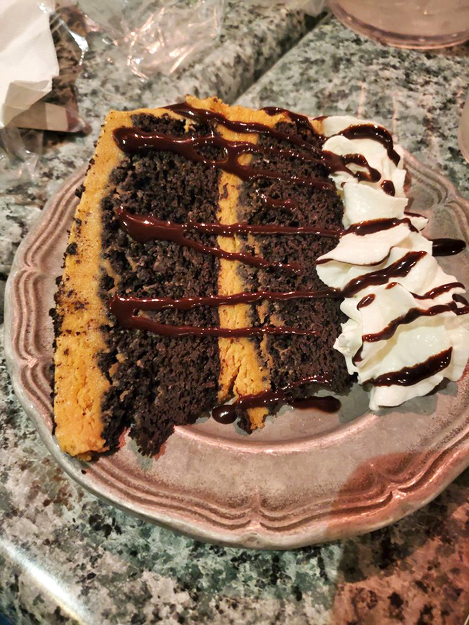 A slice of cake that doesn't just end the meal—it provides the exclamation point. That chocolate drizzle is writing love letters to your taste buds.