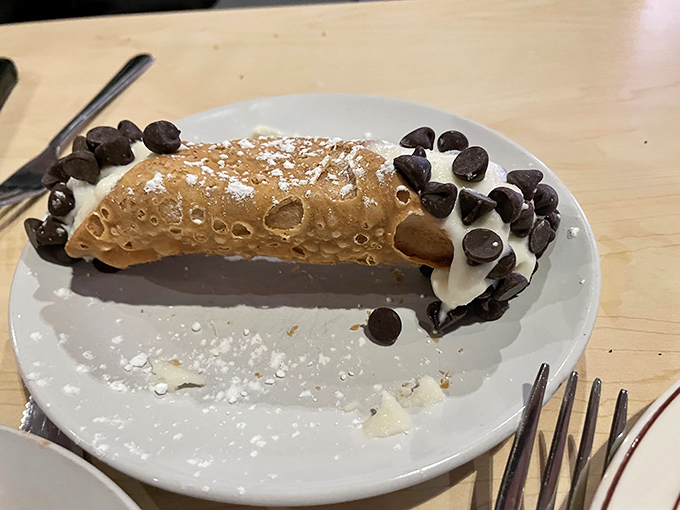 The cannoli, with its crisp shell and creamy filling studded with chocolate chips, offers the sweet finale that every Italian feast deserves.