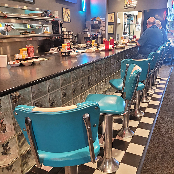 The counter seats—where solo diners become regulars and the blue chairs have witnessed more local news than the Jefferson City paper. 